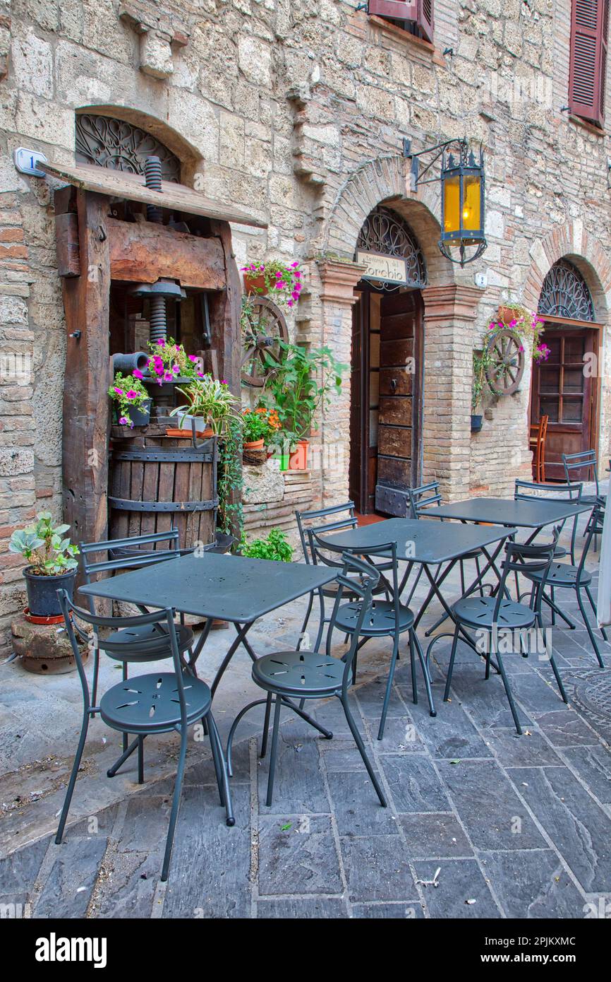 Italy, Umbria. Restaurant with outside seating in the historic town of ...