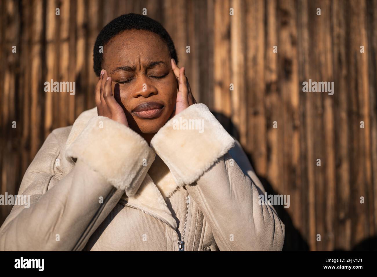 Outdoor portrait of african-american woman. She is tired and having ...