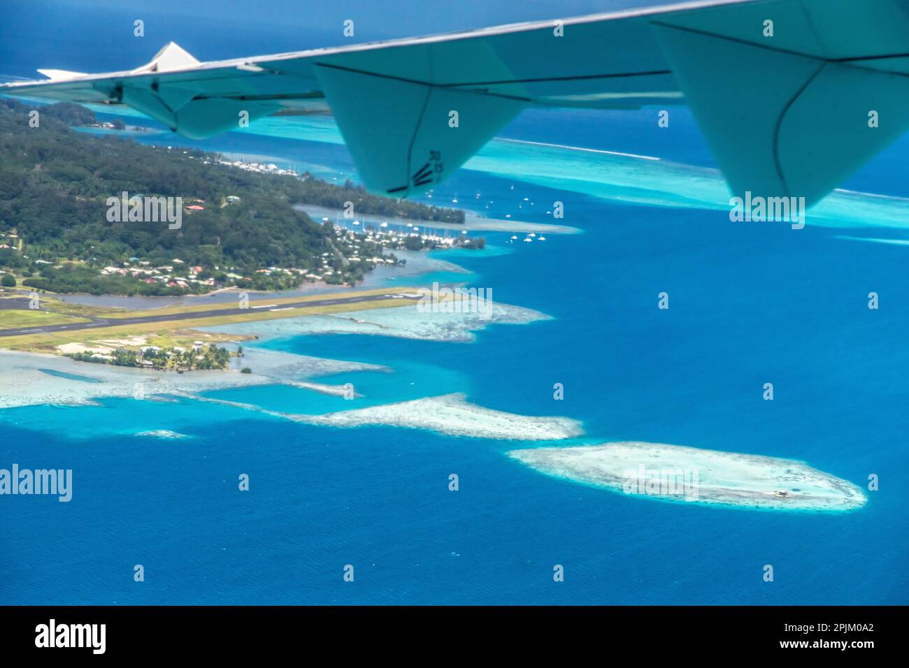 French Polynesia, Raiatea. Aerial view of island and airport runway ...
