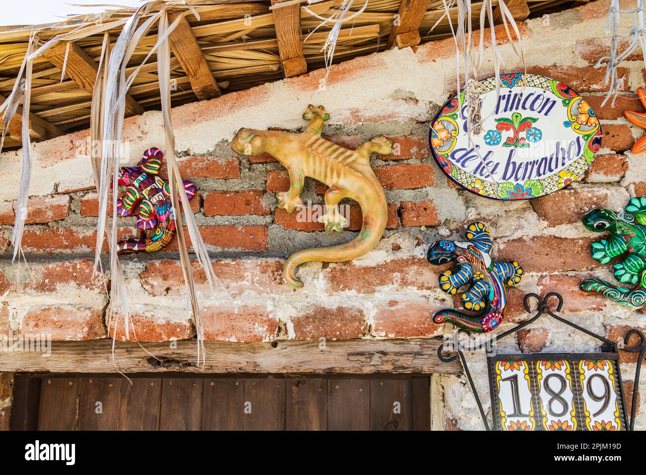 Todos Santos Baja California Sur Mexico Lizard Sculptures And A Sign Saying The Corner Of todos-santos-baja-california-sur-mexico-lizard-sculptures-and-a-sign-saying-the-corner-of