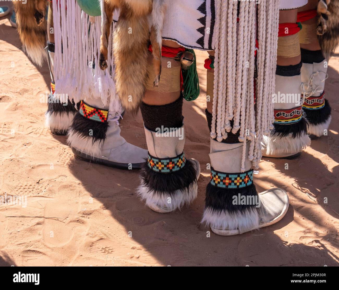 Navajo dancers in elaborate regalia waiting to begin their dance ...