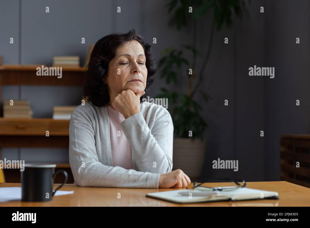 Sad tired ill sick lonely disappointed older senior woman sitting at ...