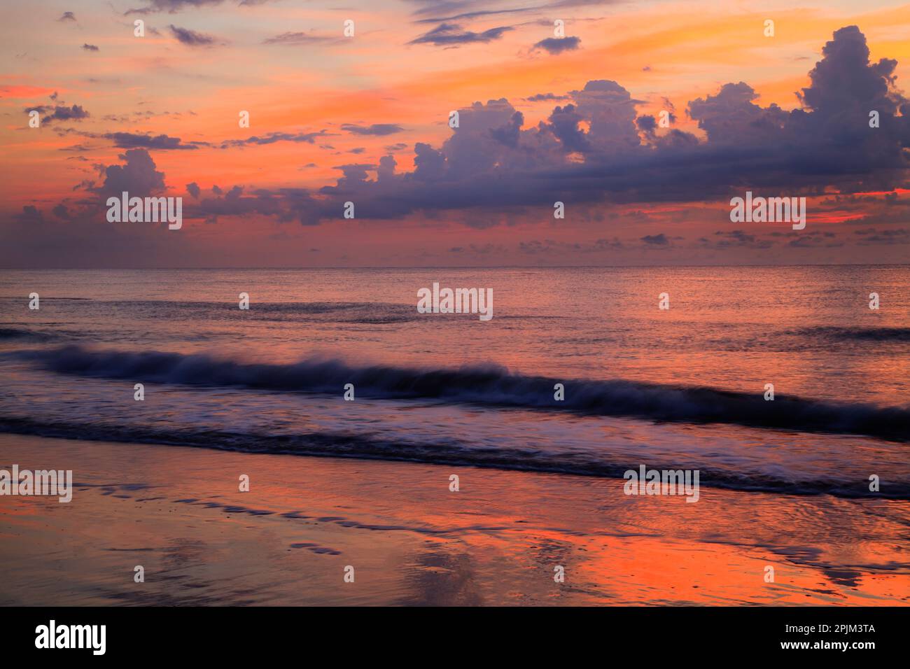 USA, Georgia, Tybee Island. Sunrise with clouds and reflections along ...