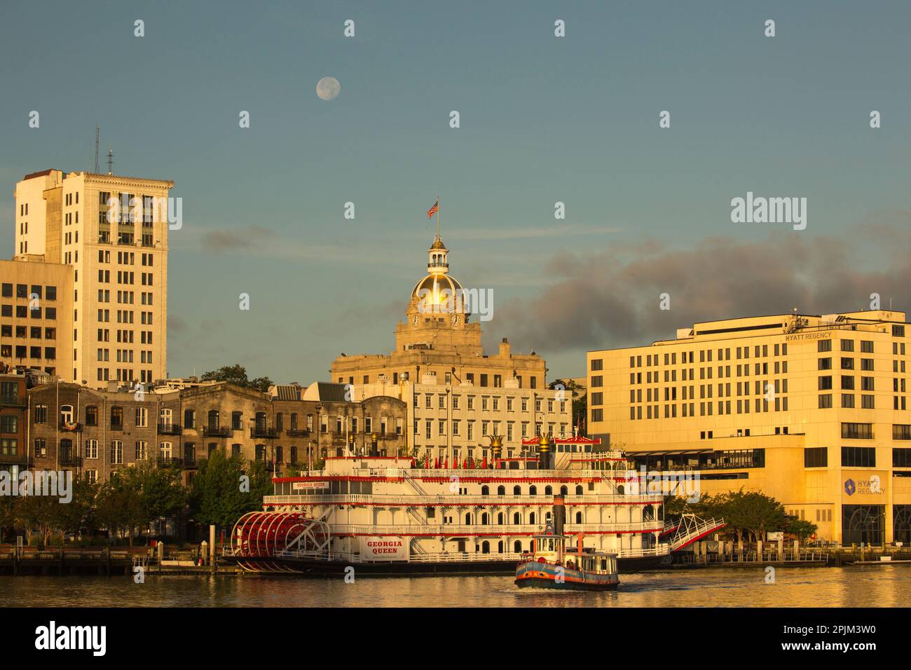 USA, Georgia, Savannah. Moon setting over City Hall along River Street ...