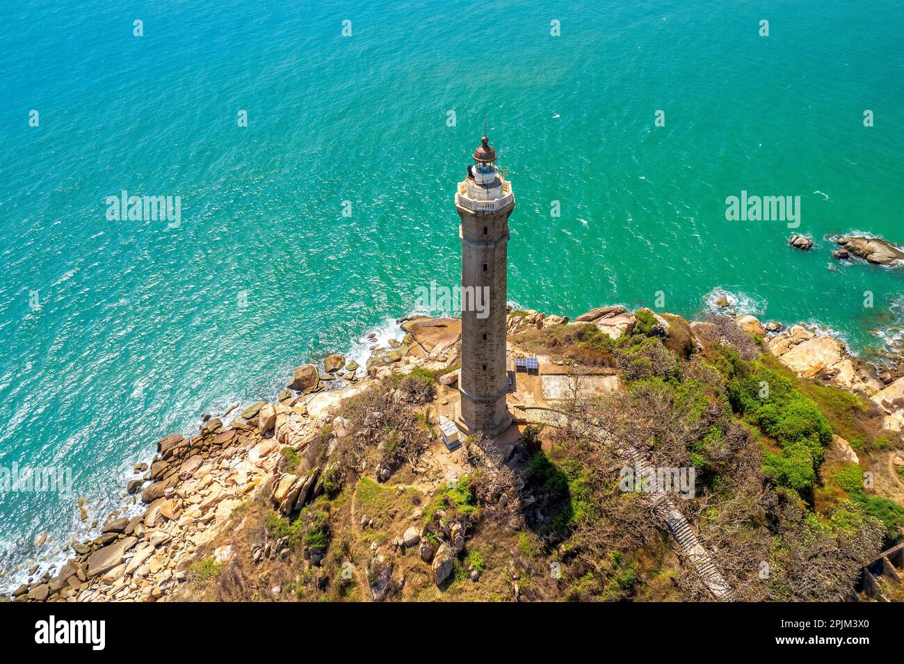 Ke Ga lighthouse is located on an island near the shore seen from above ...