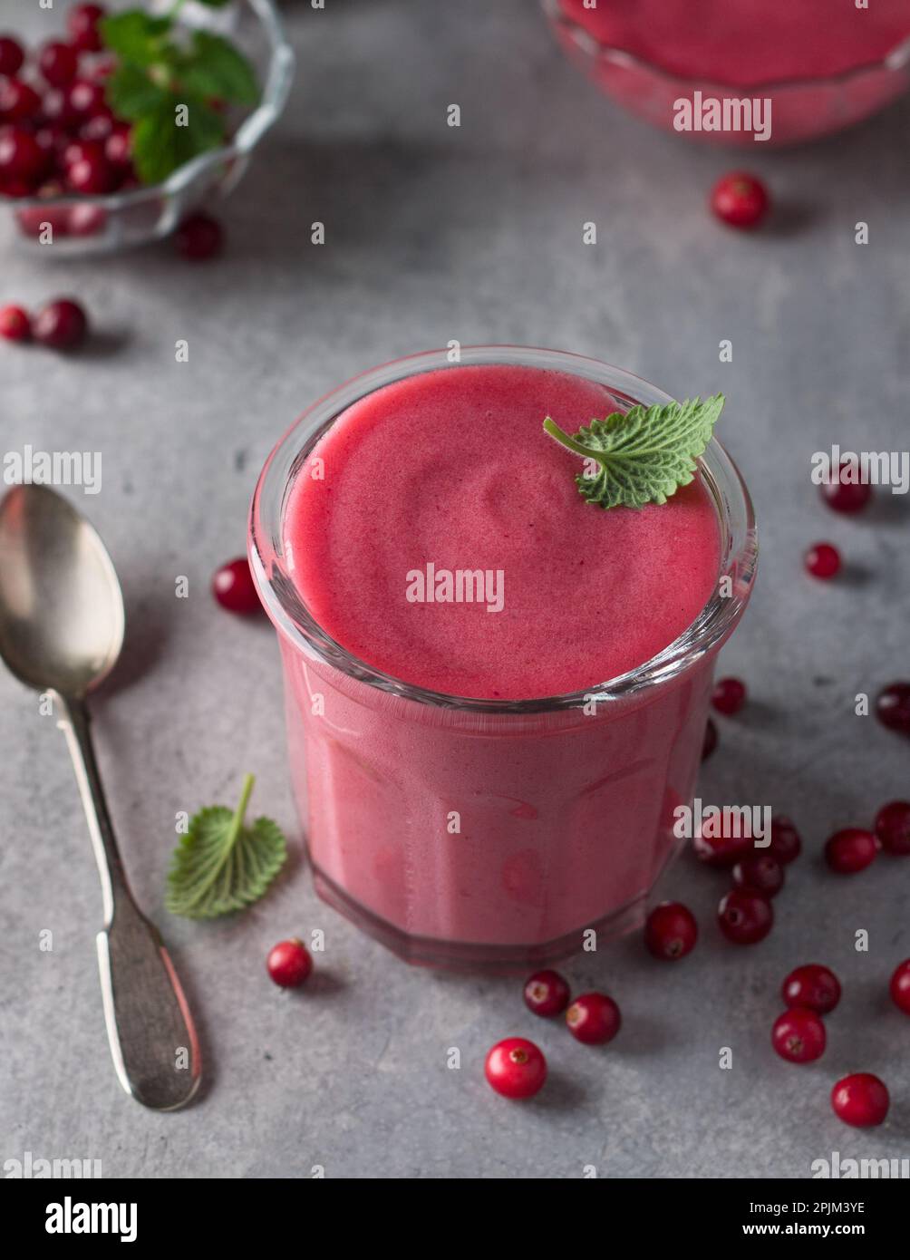 Vegan cranberry mousse with semolina and fresh cranberries on gray ...