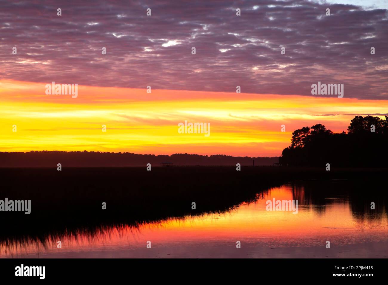 USA, Georgia. Sunrise reflections in marsh at Grimball Point Stock ...