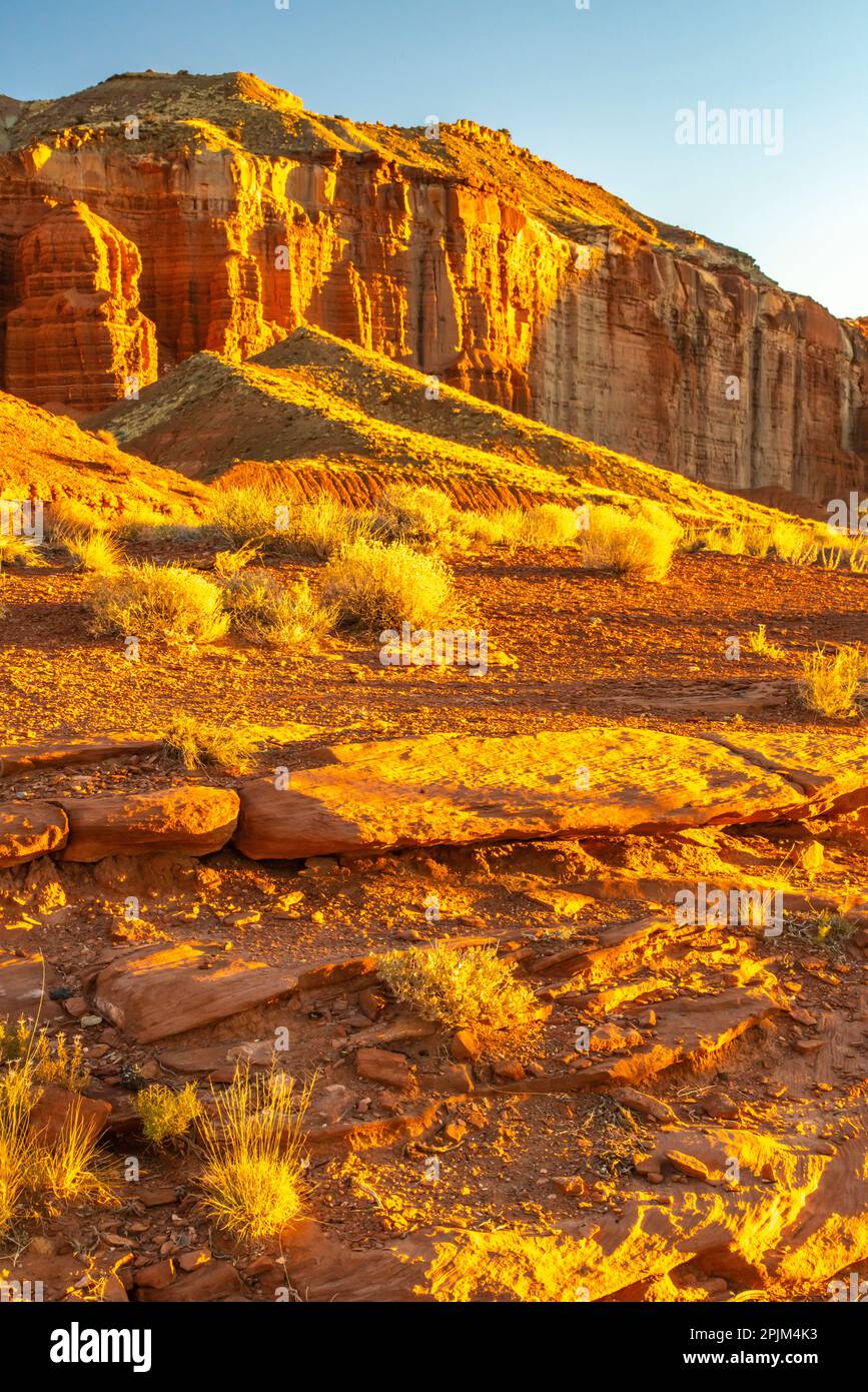 USA, Utah, Capitol Reef National Park. Sunrise on eroded cliff ...
