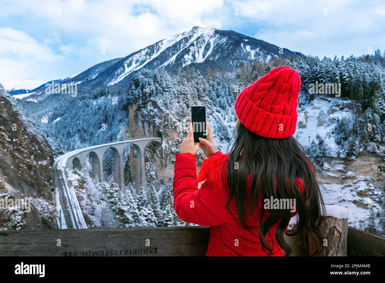 Tourist visiting Landwasser Viaduct world heritage in Swiss Alps snow ...