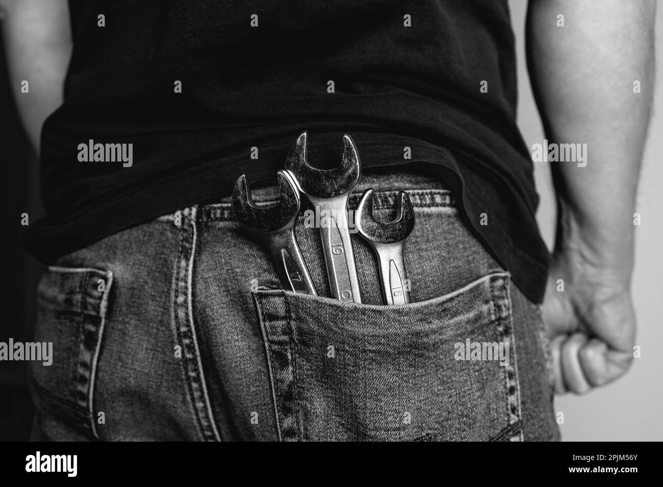 Man with wrenches in back pocket of his jeans. Ideal for industrial ...