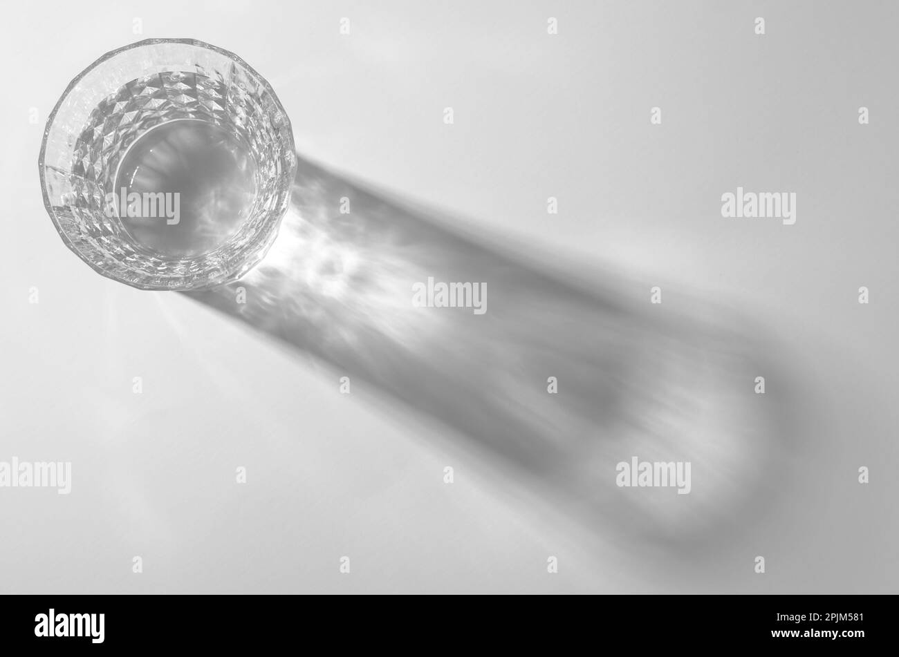 A Glass with Water and Sharp Shadows, Caustic Effect as Light Passes ...