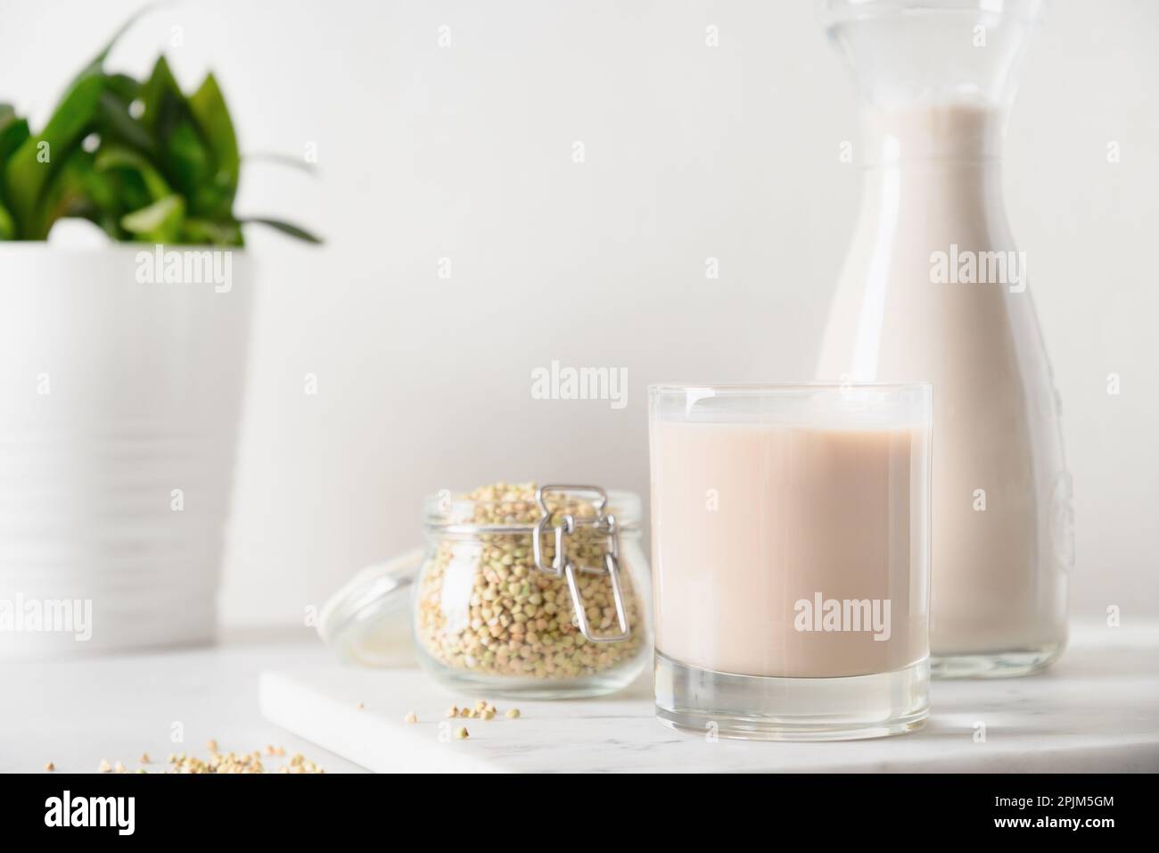 Vegan green buckwheat milk in glass. Alternative plant based milk ...