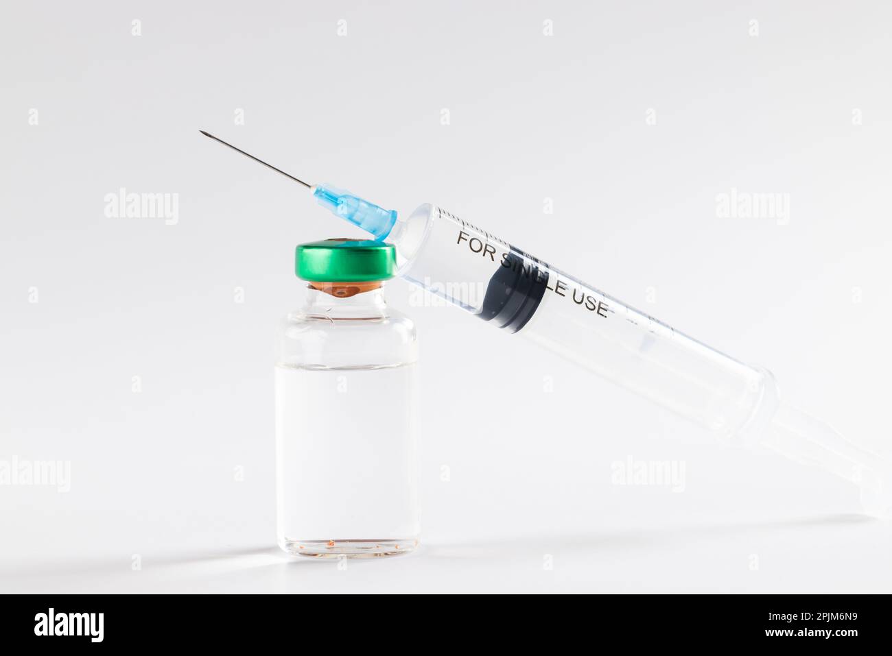 Vial of clear liquid and large syringe on white background Stock Photo ...
