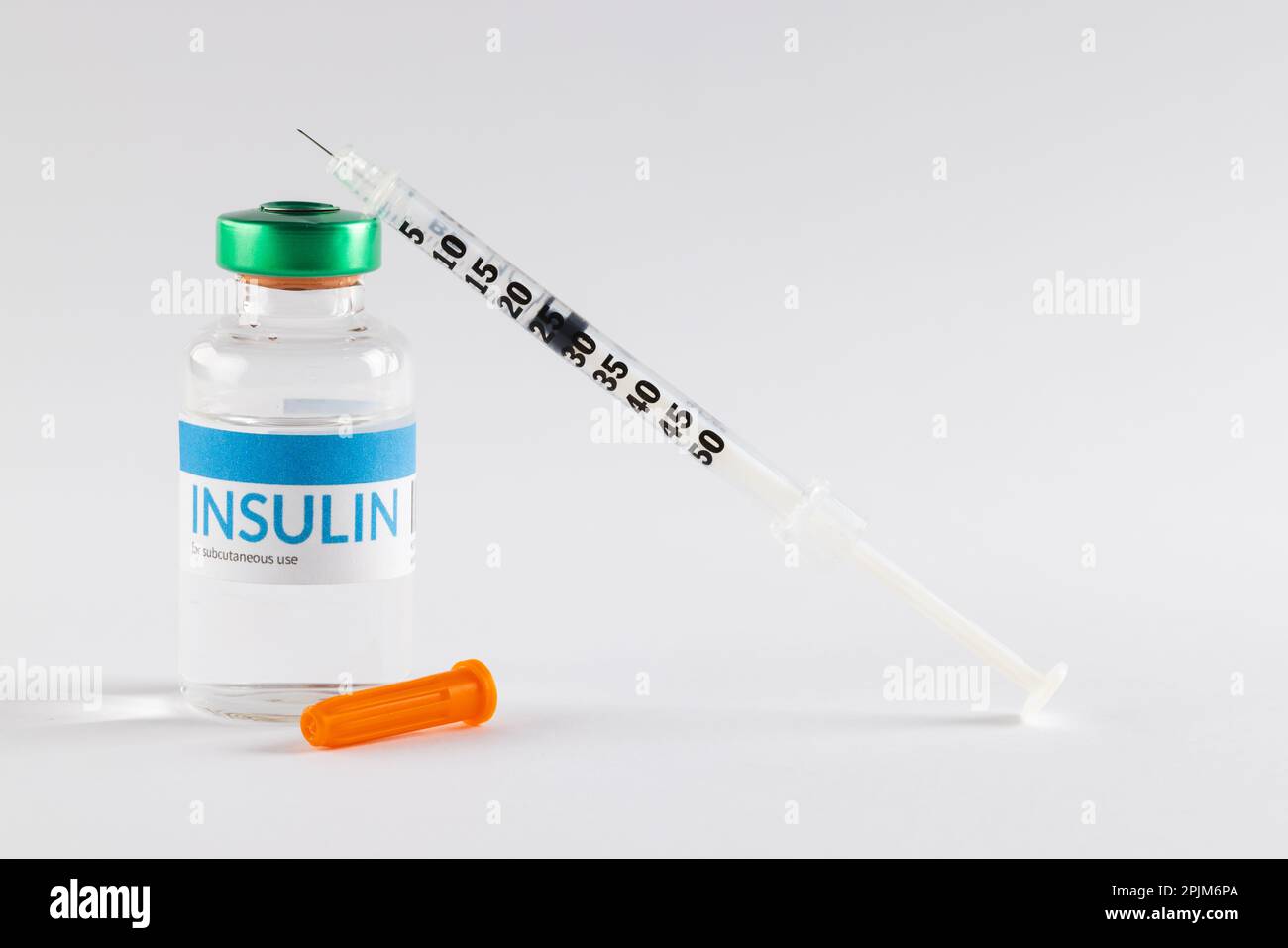 Insulin in vial and uncapped syringe on white background Stock Photo ...