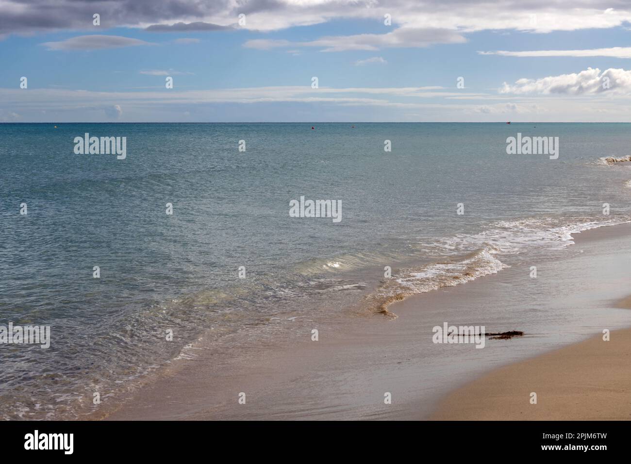 Famous sandy beach in the south-east part of the island. Blue sky with ...