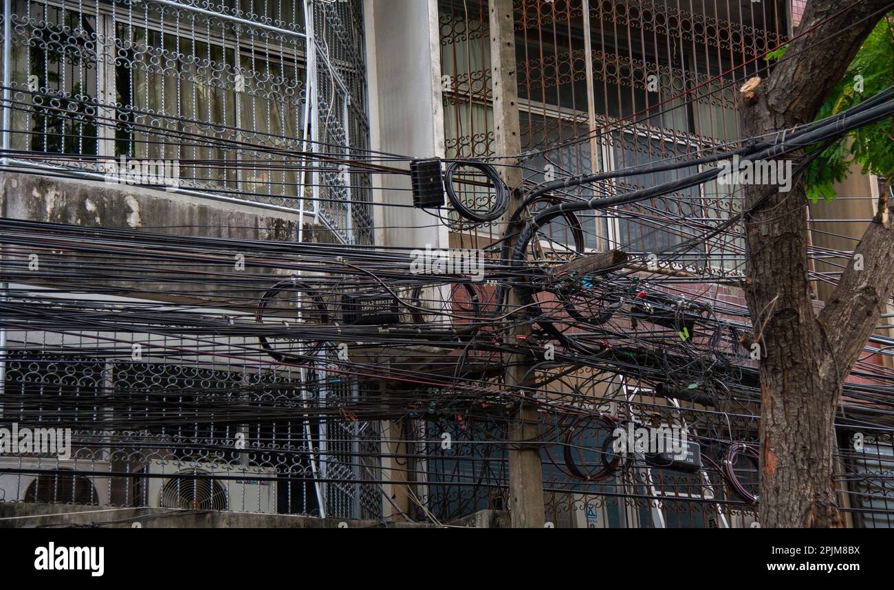 Messy electricity and internet wires on pole, Chaos of cables and wires ...