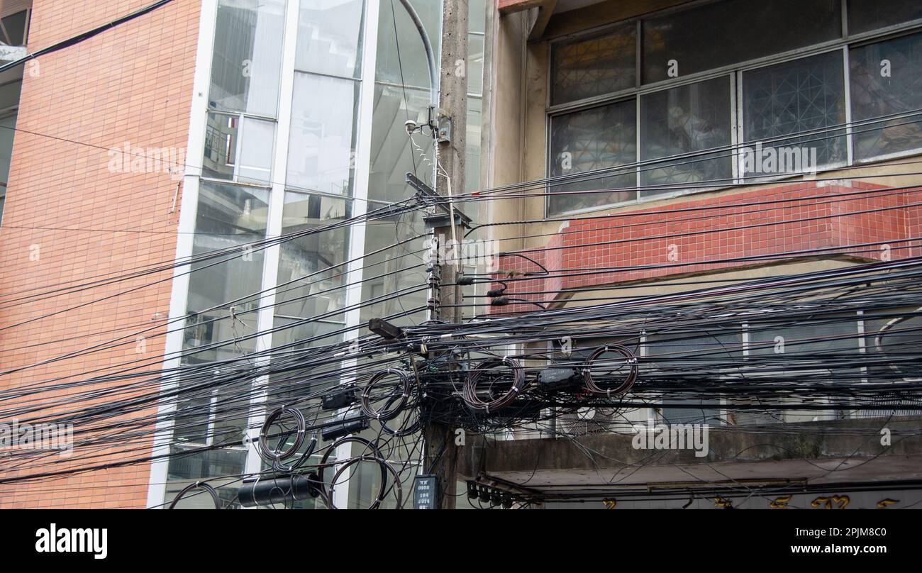 Messy electricity and internet wires on pole, Chaos of cables and wires ...