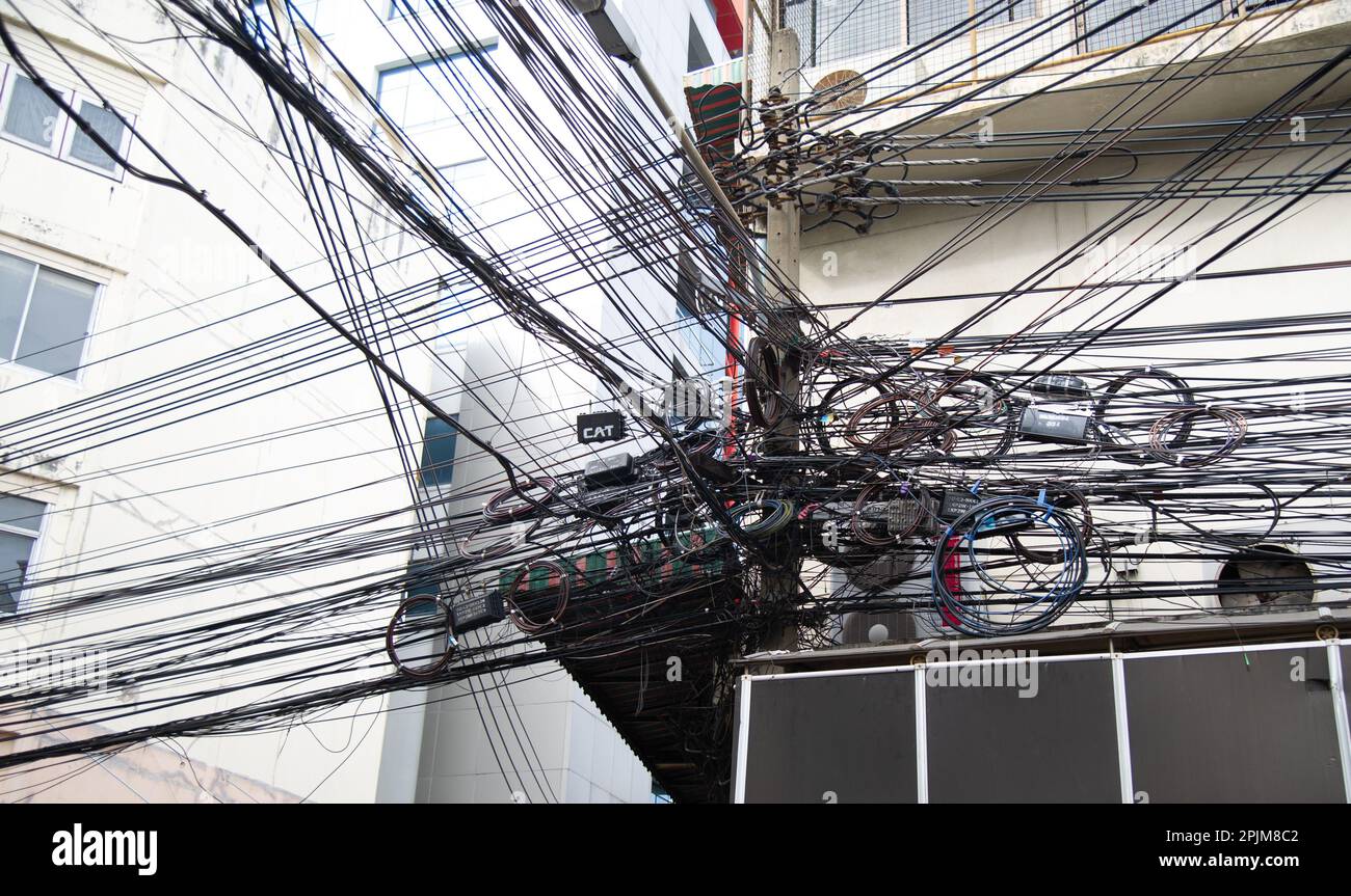 Messy electricity and internet wires on pole, Chaos of cables and wires ...