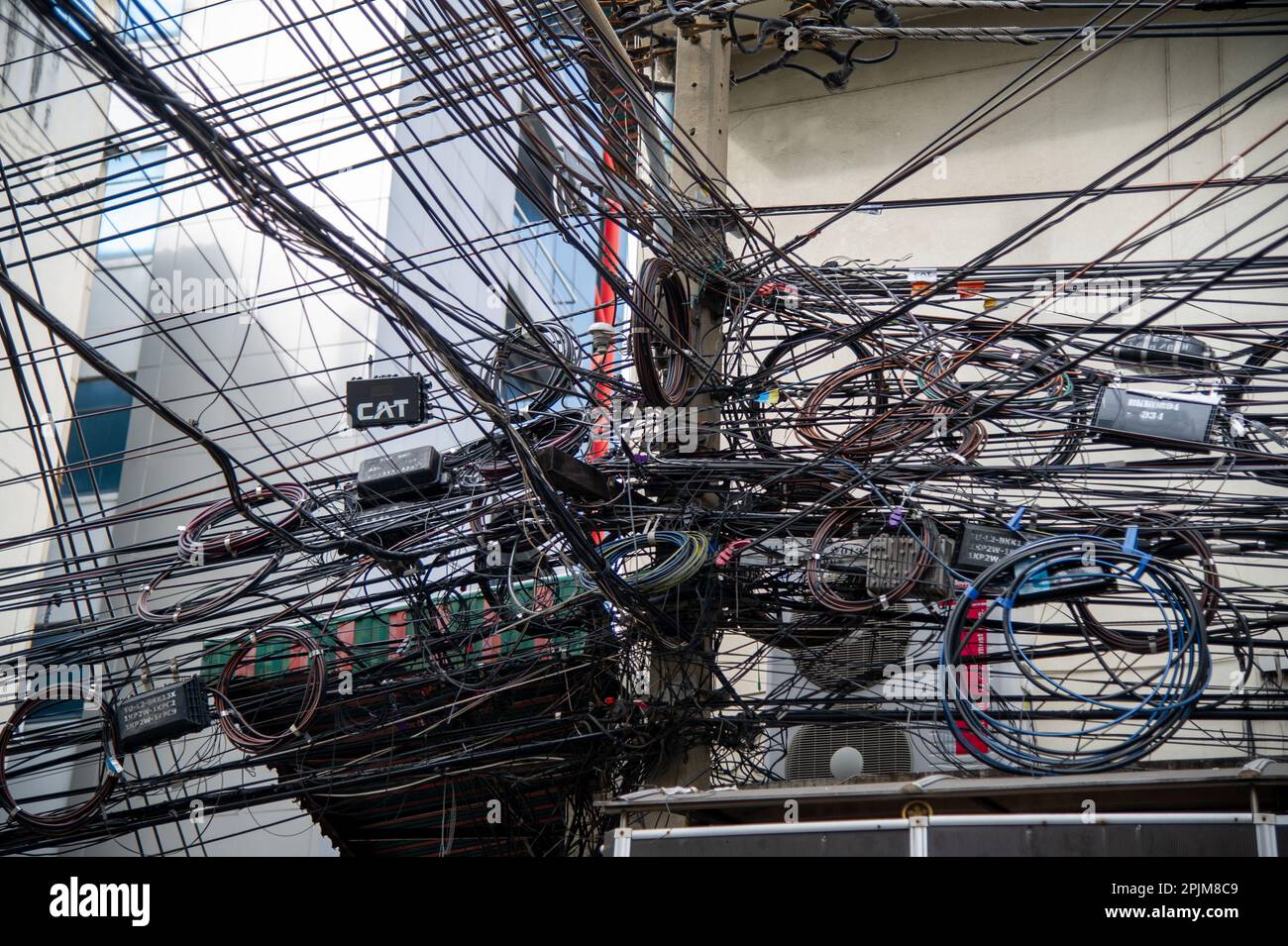 Messy electricity and internet wires on pole, Chaos of cables and wires ...