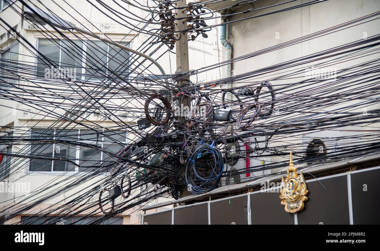 Messy electricity and internet wires on pole, Chaos of cables and wires ...