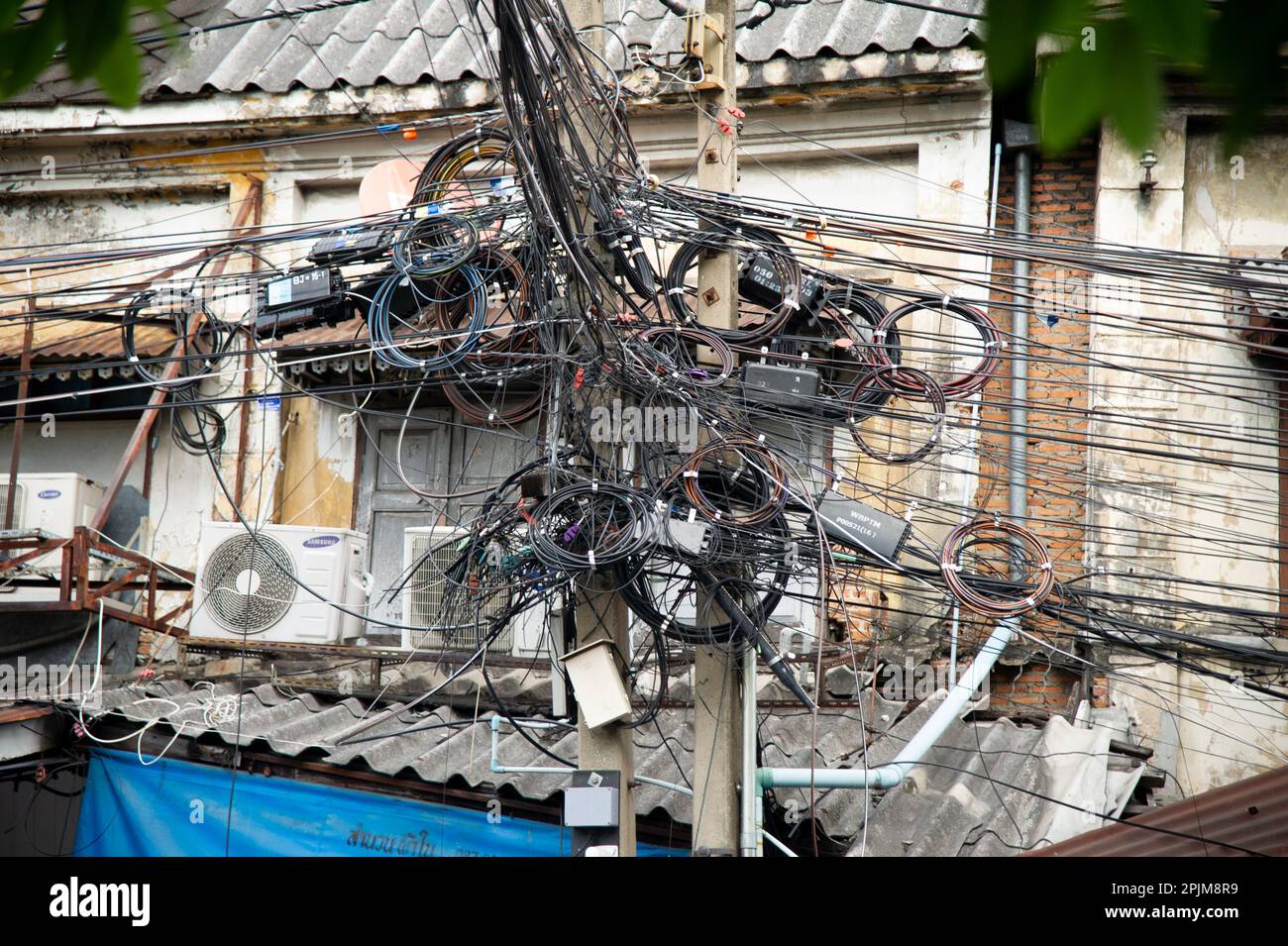 Messy electricity and internet wires on pole, Chaos of cables and wires ...