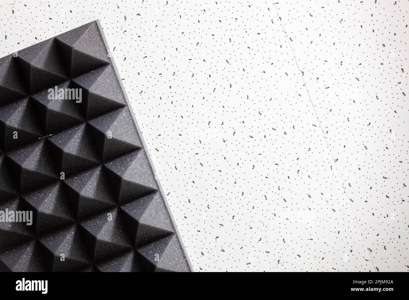 Two backgrounds on one wall. Professional soundproofing and plain white ...