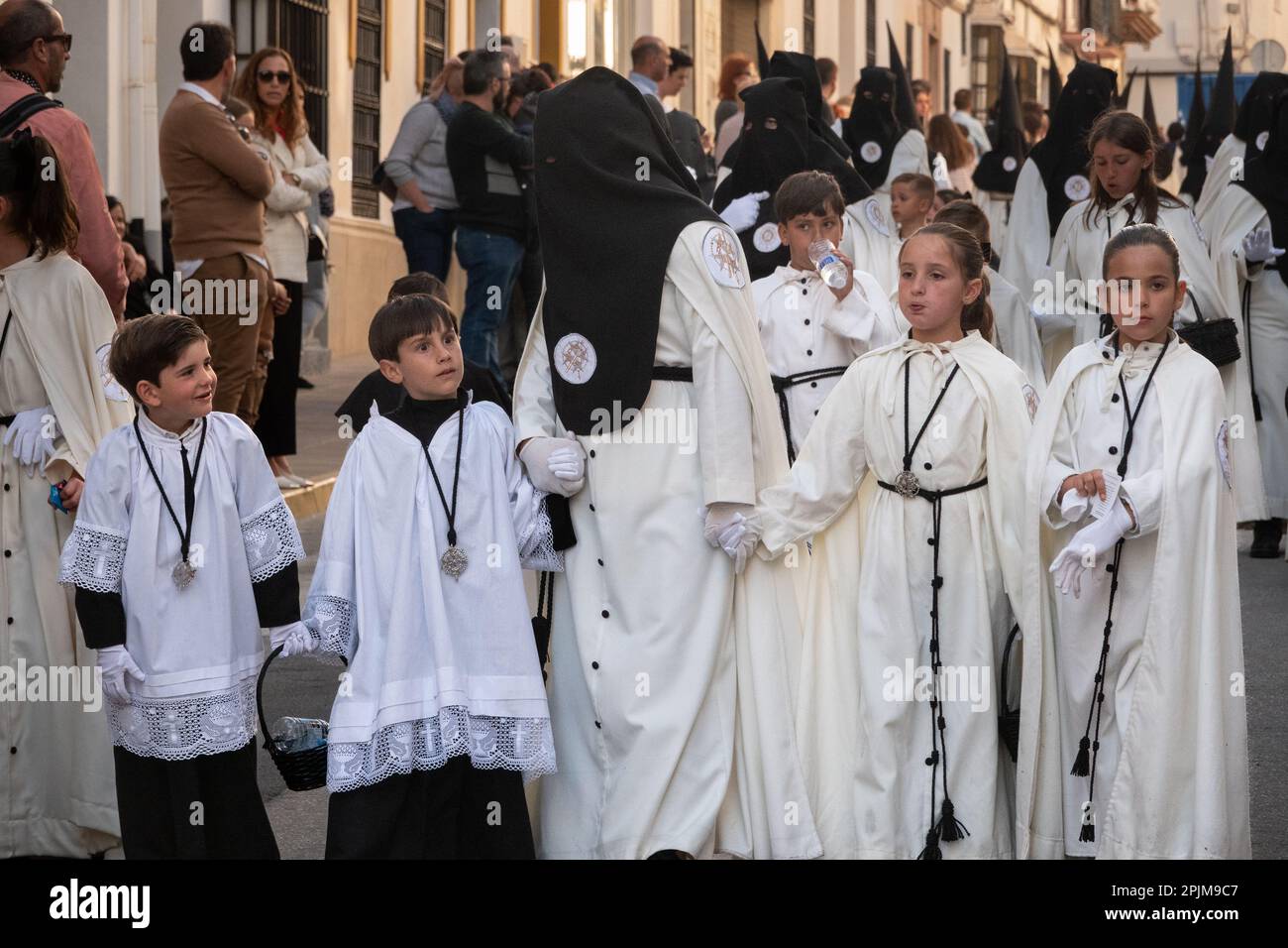 Ronda, Spain. 02nd Apr, 2023. A woman holds hands with children before ...