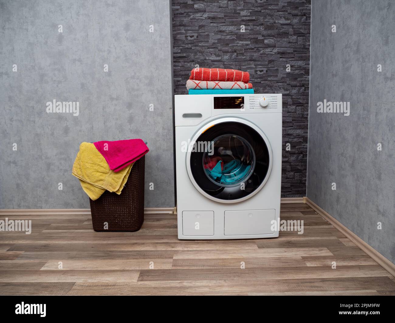 Laundry room interior with washing machine against the wall. Modern ...