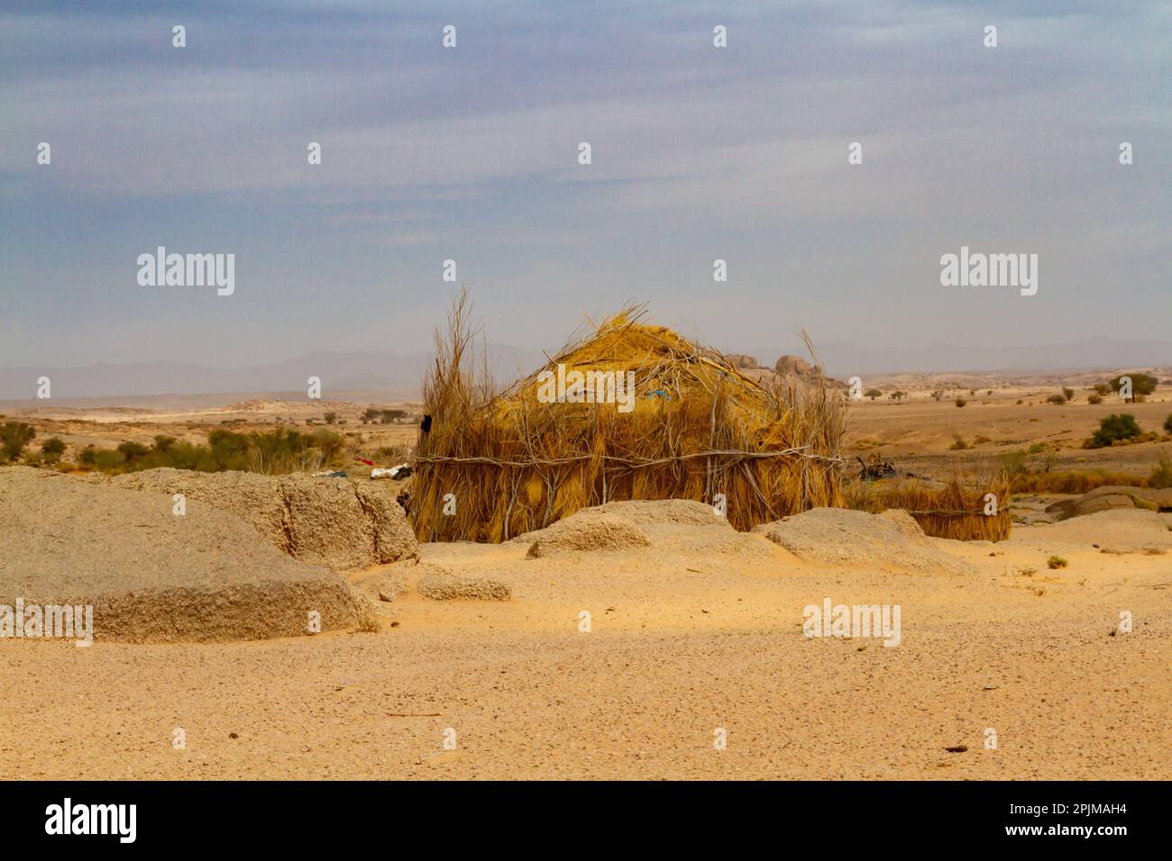 Tuareg encampment in the desert. Round hut built in a traditional way ...