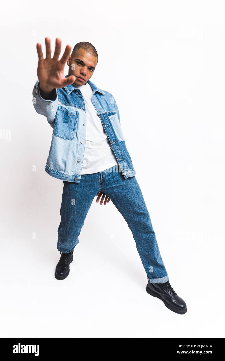 Balancing pose from confident adult man in denim set working as a model ...