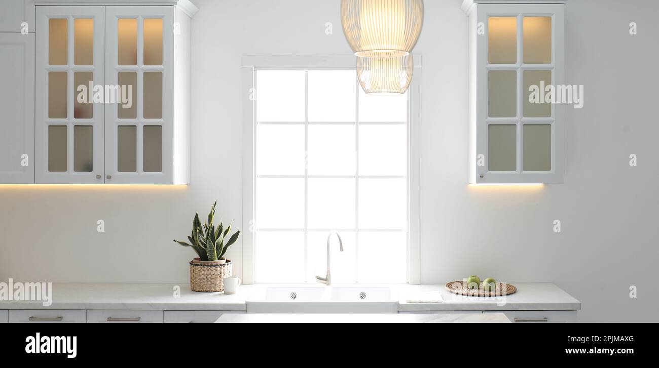 New ceramic sink and modern tap in stylish kitchen interior. Banner ...