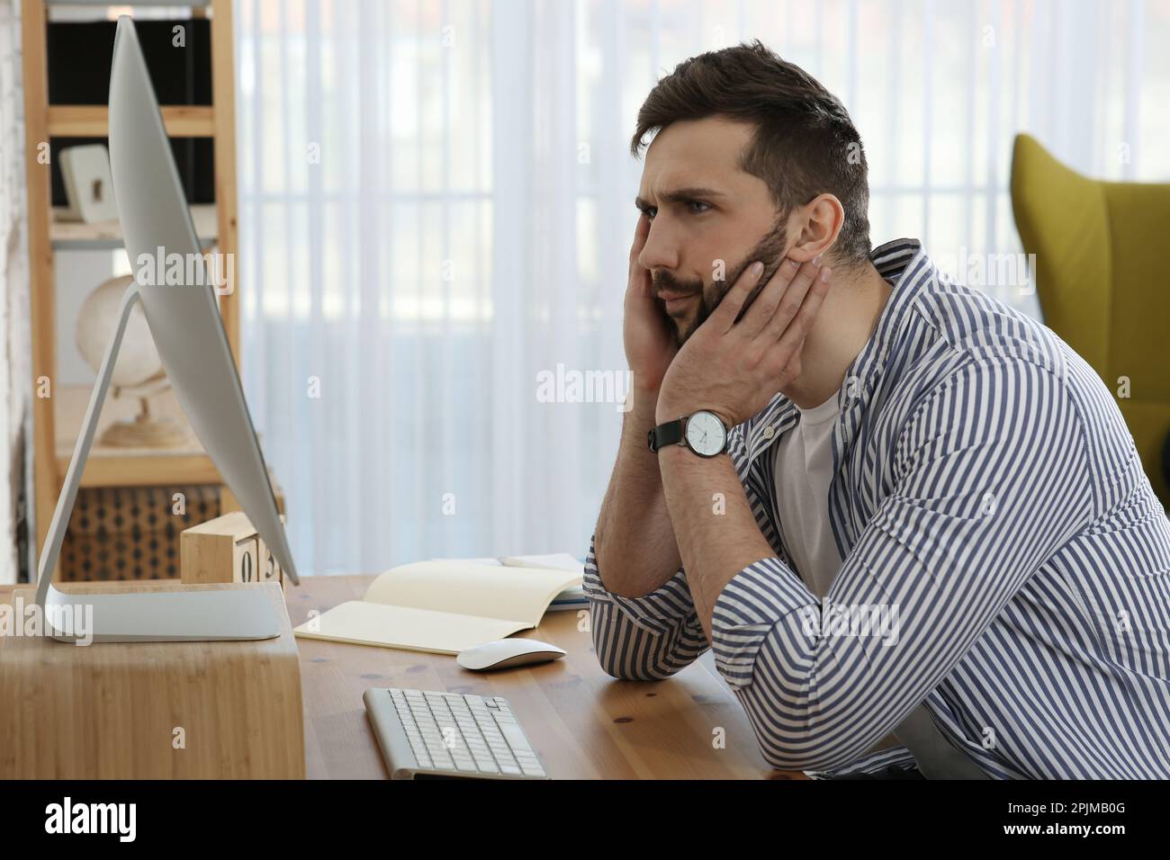Online test. Man studying with computer at home Stock Photo - Alamy