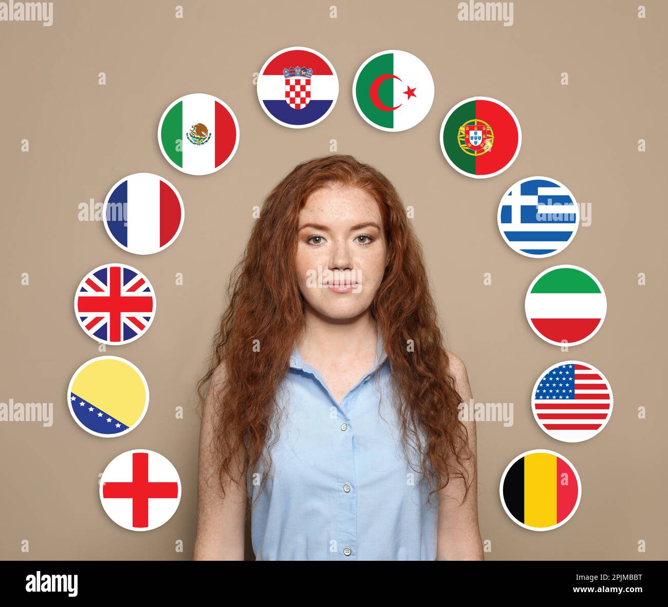 Portrait of young interpreter and flags of different countries on beige ...