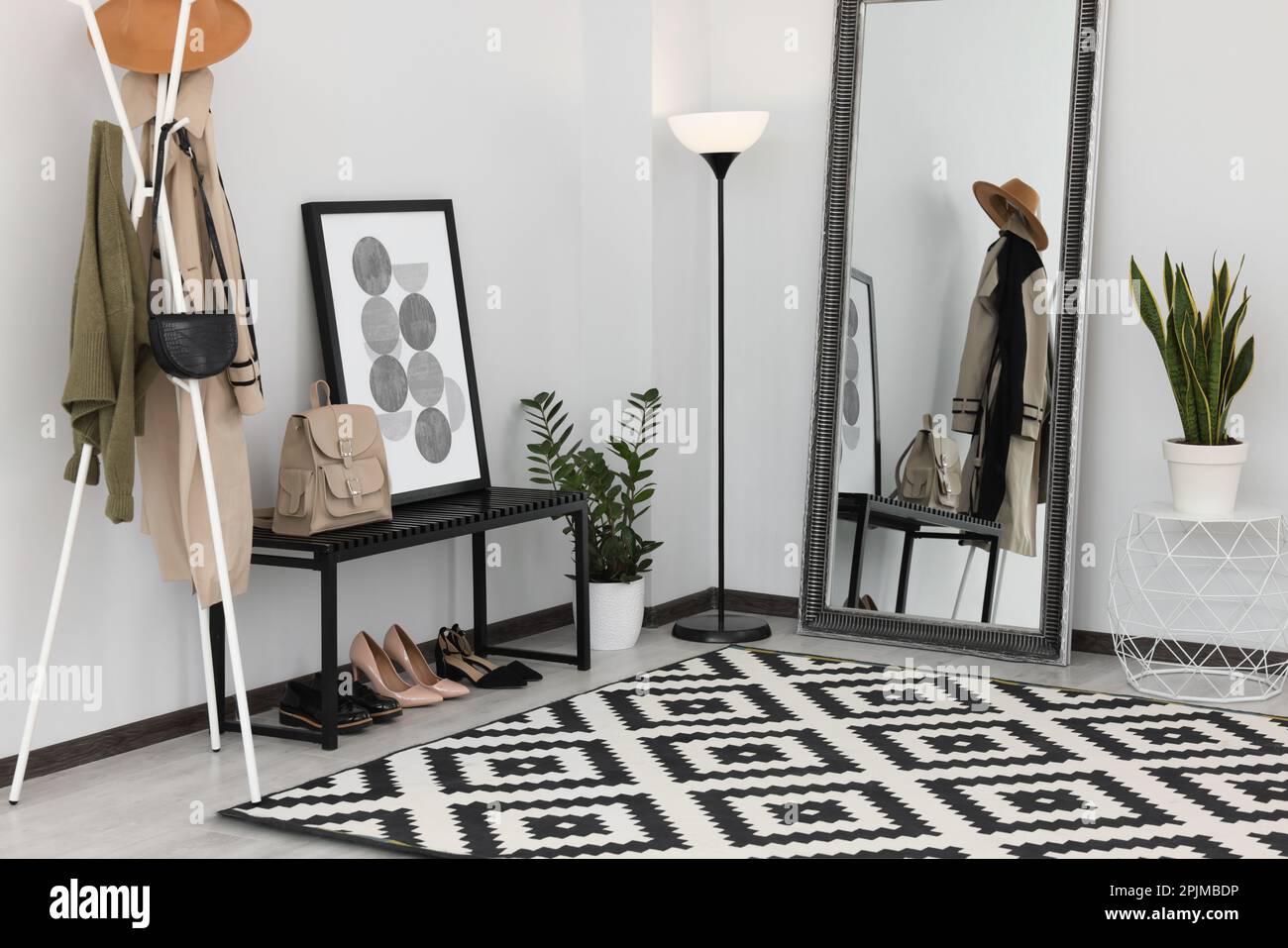Stylish hallway room interior with bench, shoes, clothes rack and floor ...