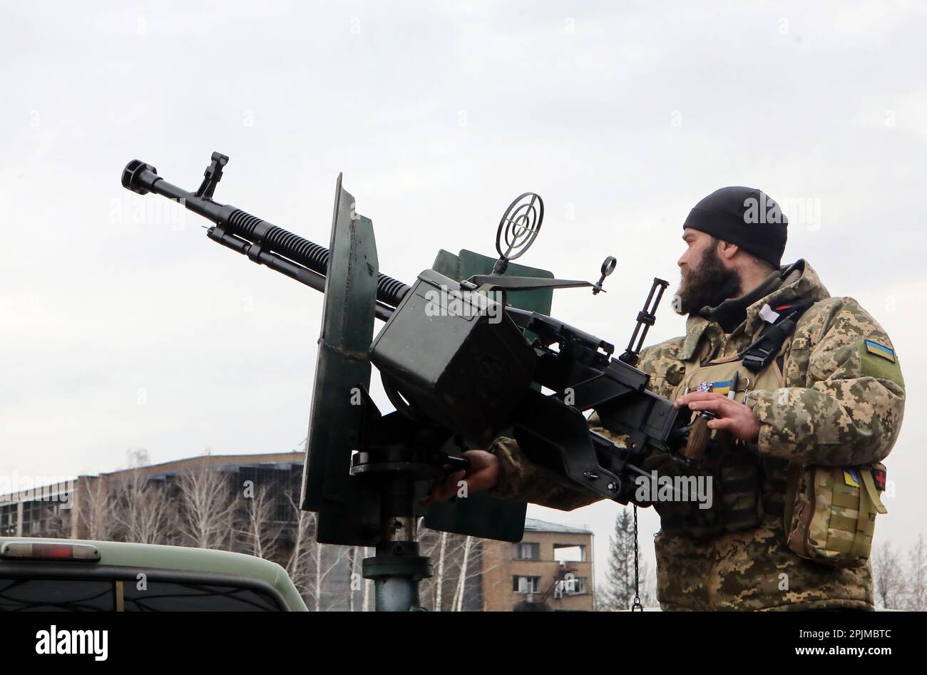 HOSTOMEL, UKRAINE - APRIL 1, 2023 - A serviceman stands behind a ...