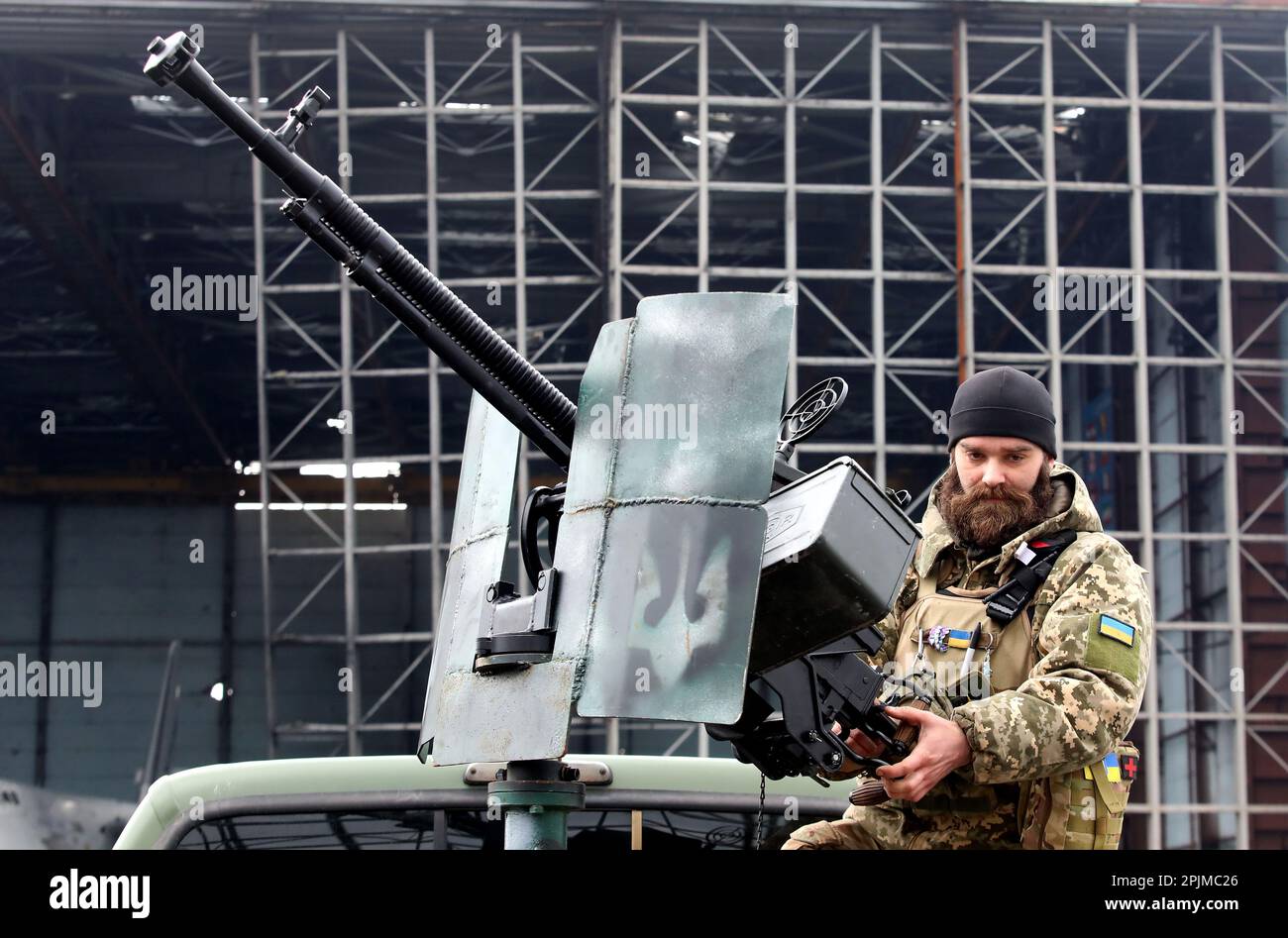 HOSTOMEL, UKRAINE - APRIL 1, 2023 - A serviceman stands behind a ...