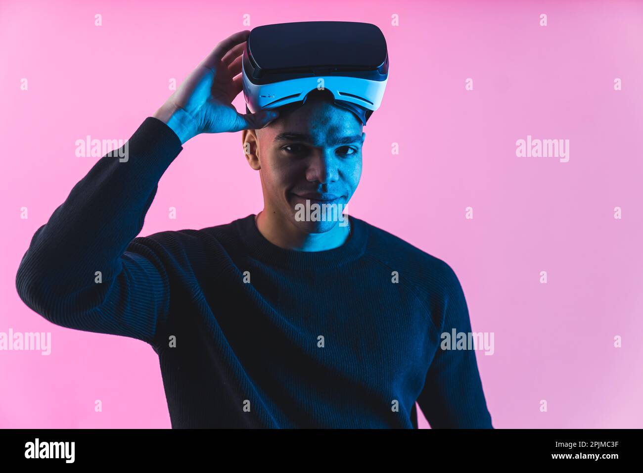 Modern free time activities. Confident young adult man taking off ...