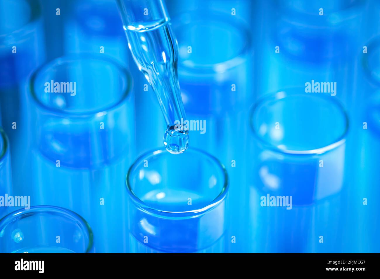 Dripping reagent into test tube with blue liquid, closeup. Laboratory ...