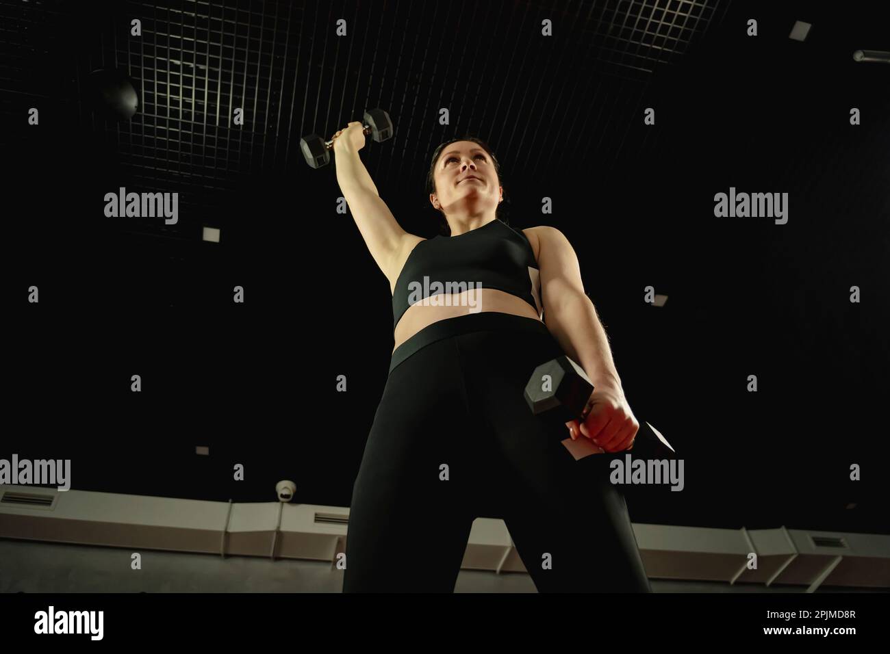 woman doing fitness. Professional female bodybuilder training muscles ...