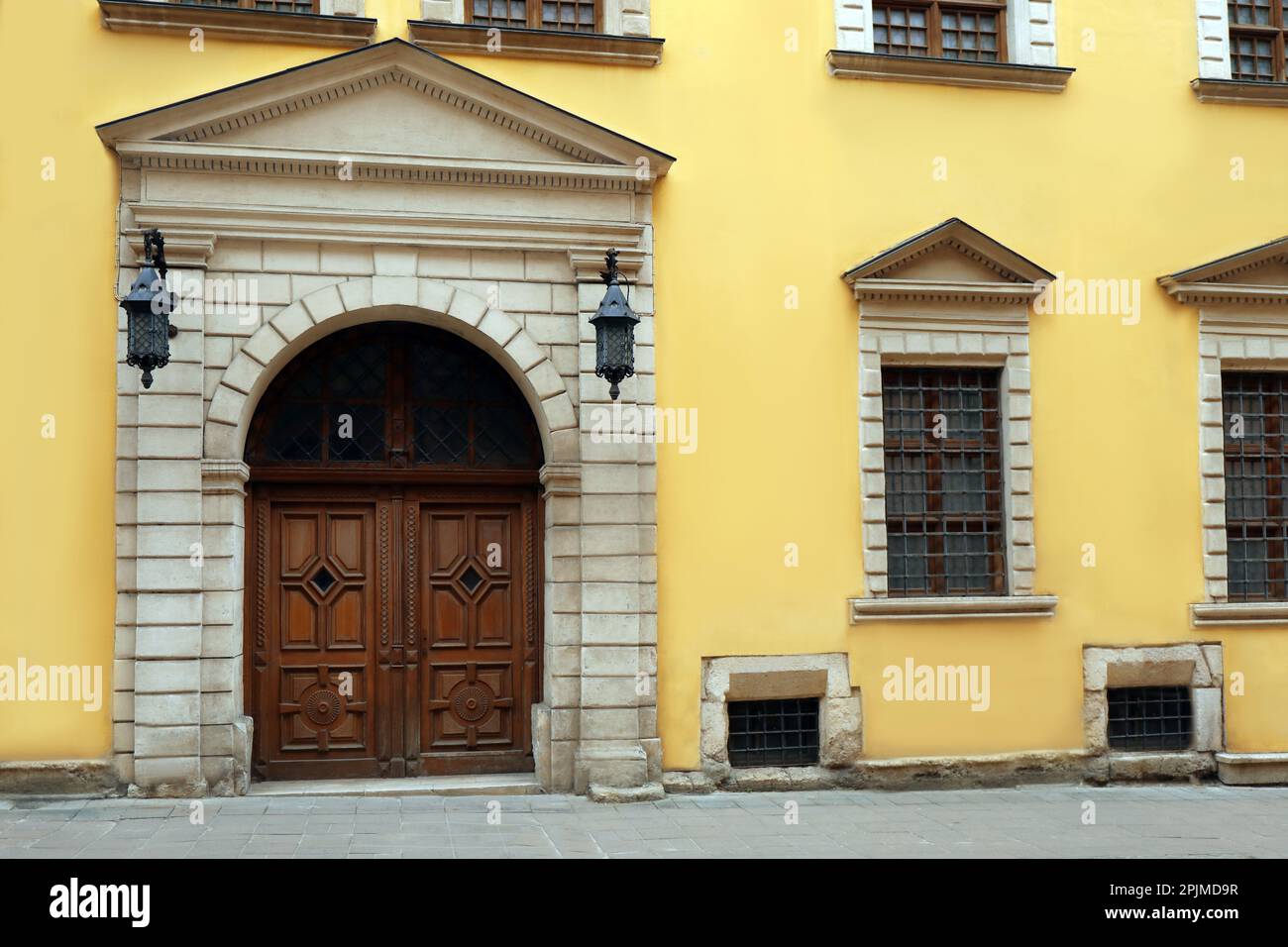 View of house with beautiful arched wooden door and grated windows ...