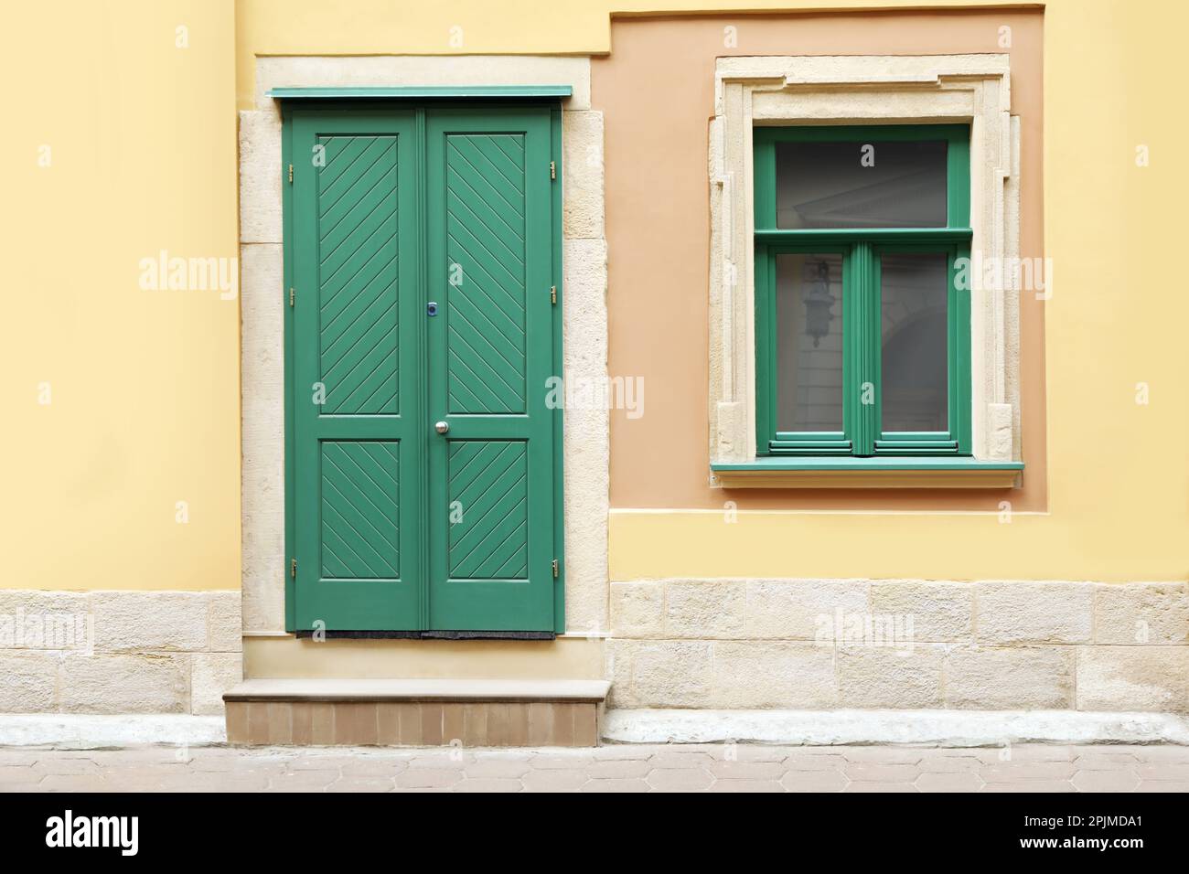 View of building with turquoise wooden door and window. Exterior design ...