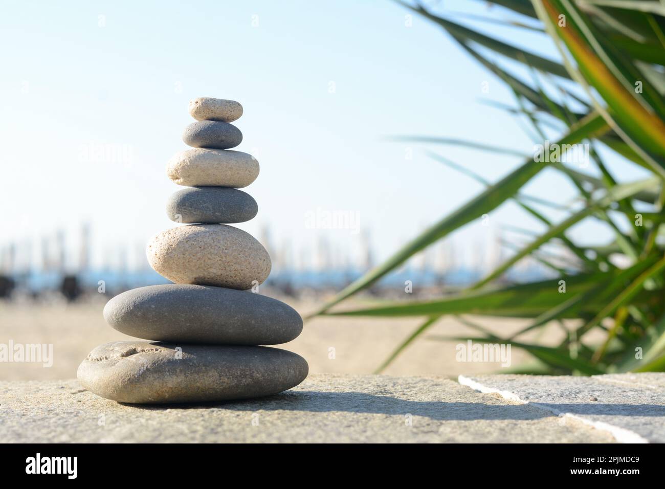 Stack of stones on parapet near sea, space for text Stock Photo - Alamy