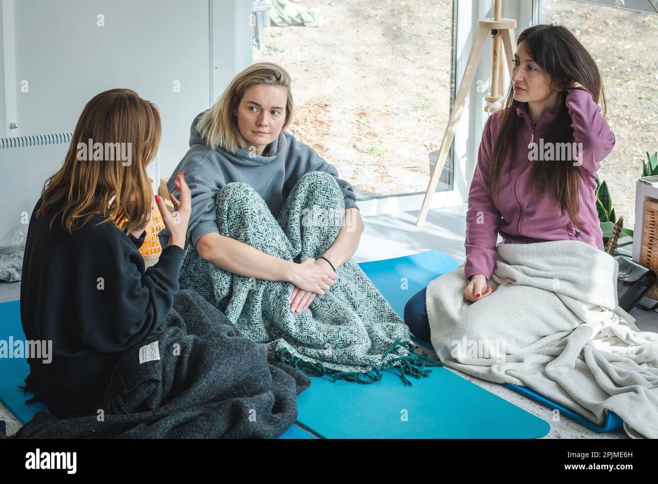 Young caucasian beautiful girls enjoying time together during a yoga ...