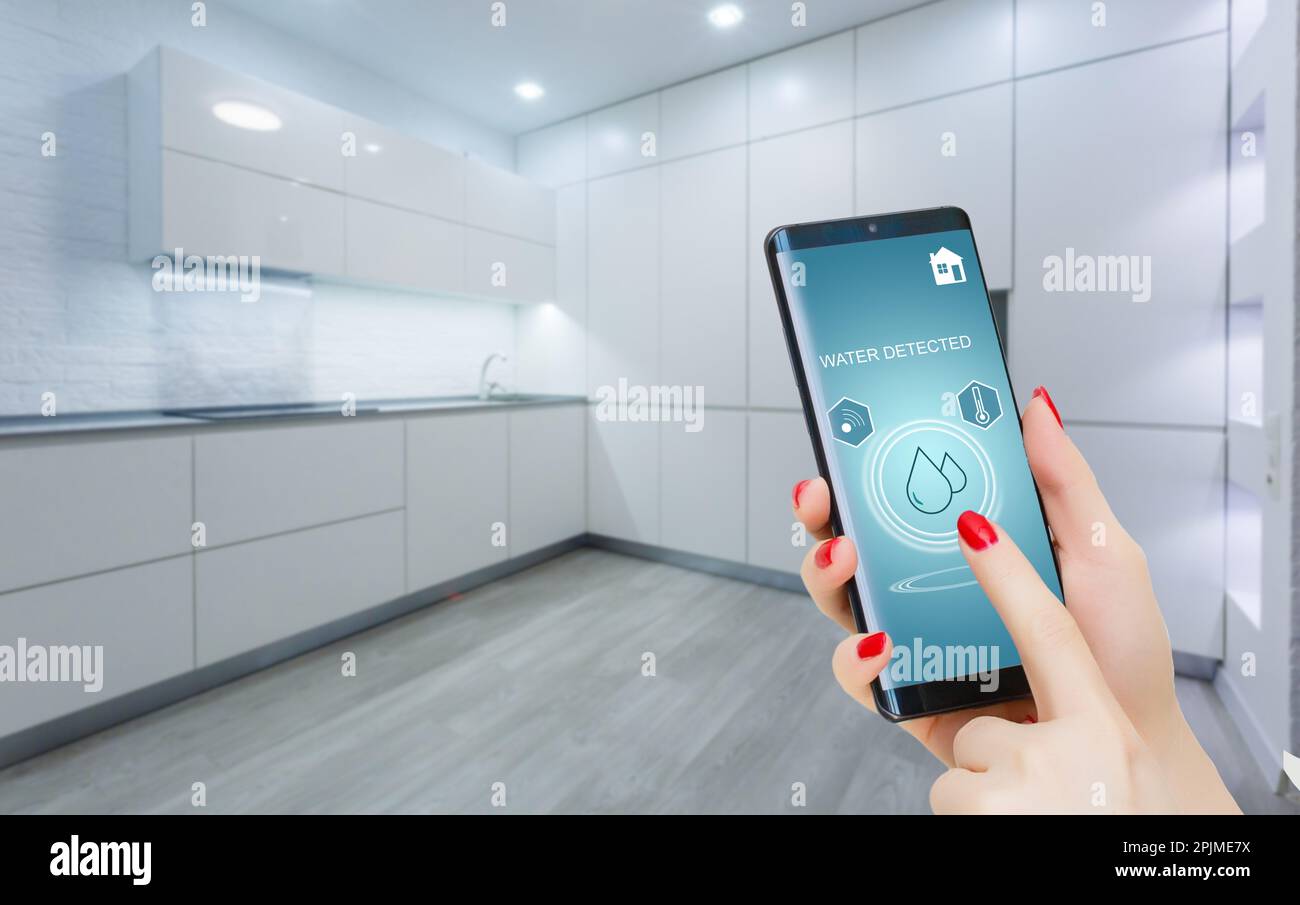 Hand holding smart phone with home control application with water ...