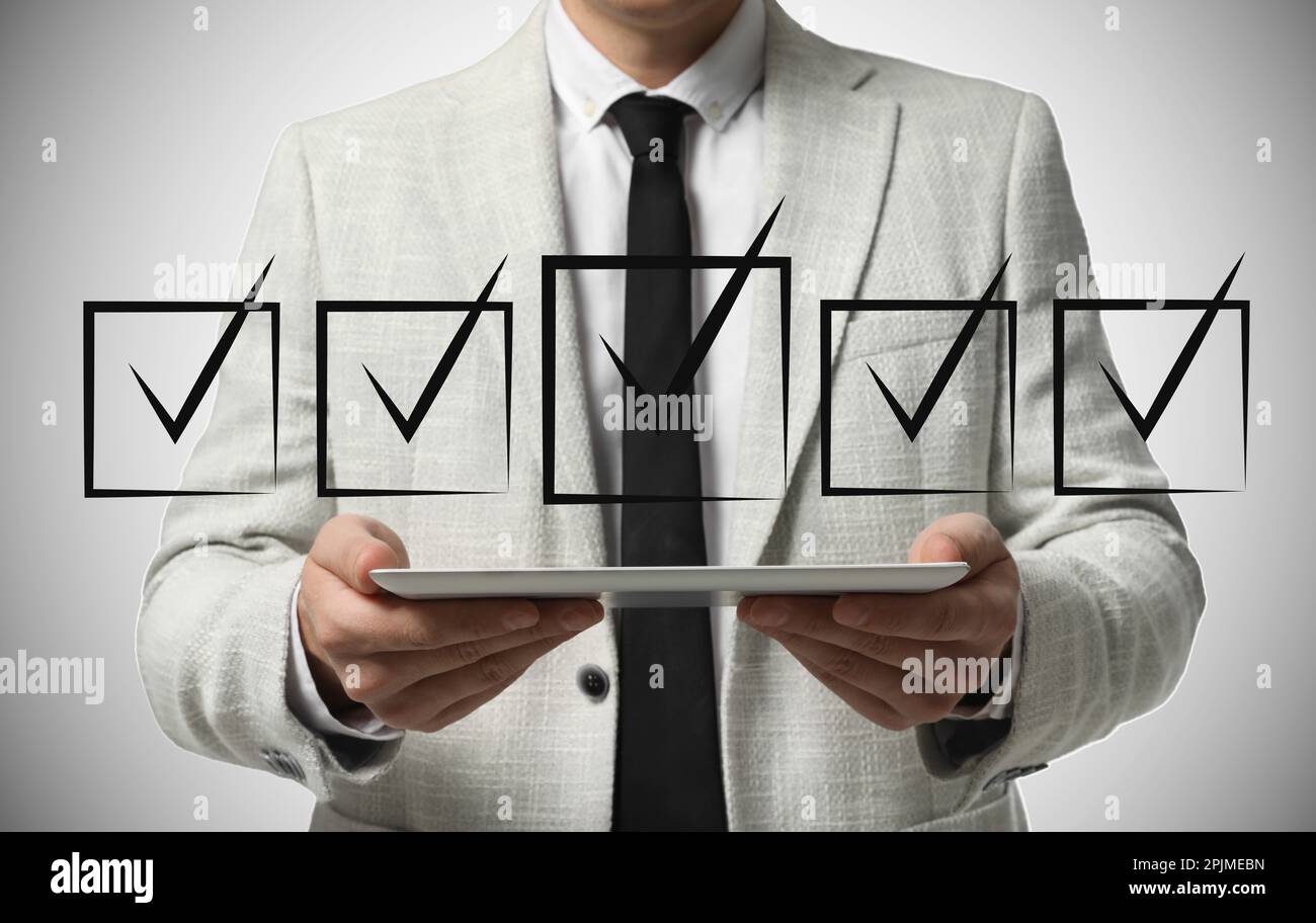 Illustration of check boxes with marks and man using tablet on light ...