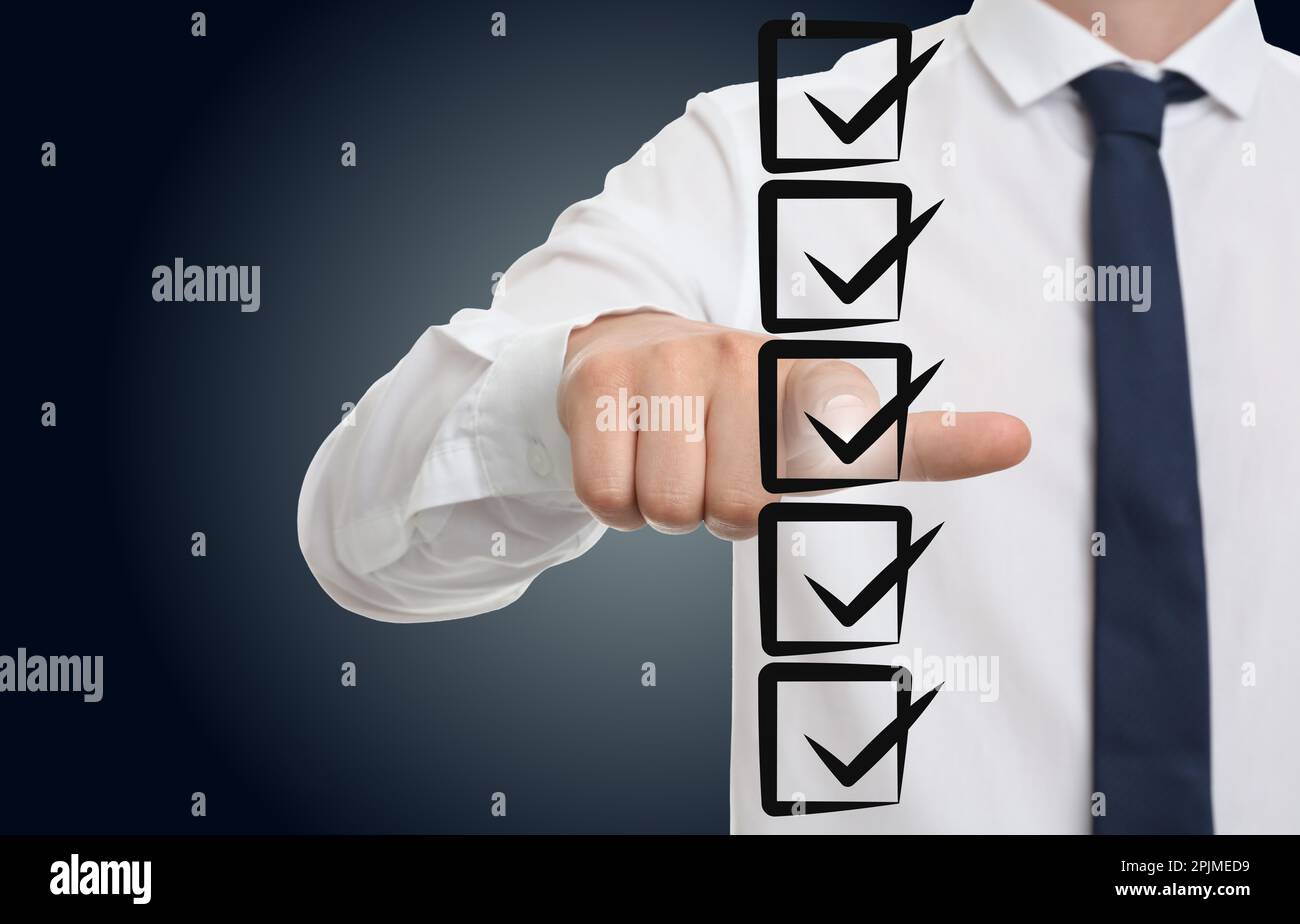 Man pointing at check boxes with marks on virtual screen, closeup Stock ...