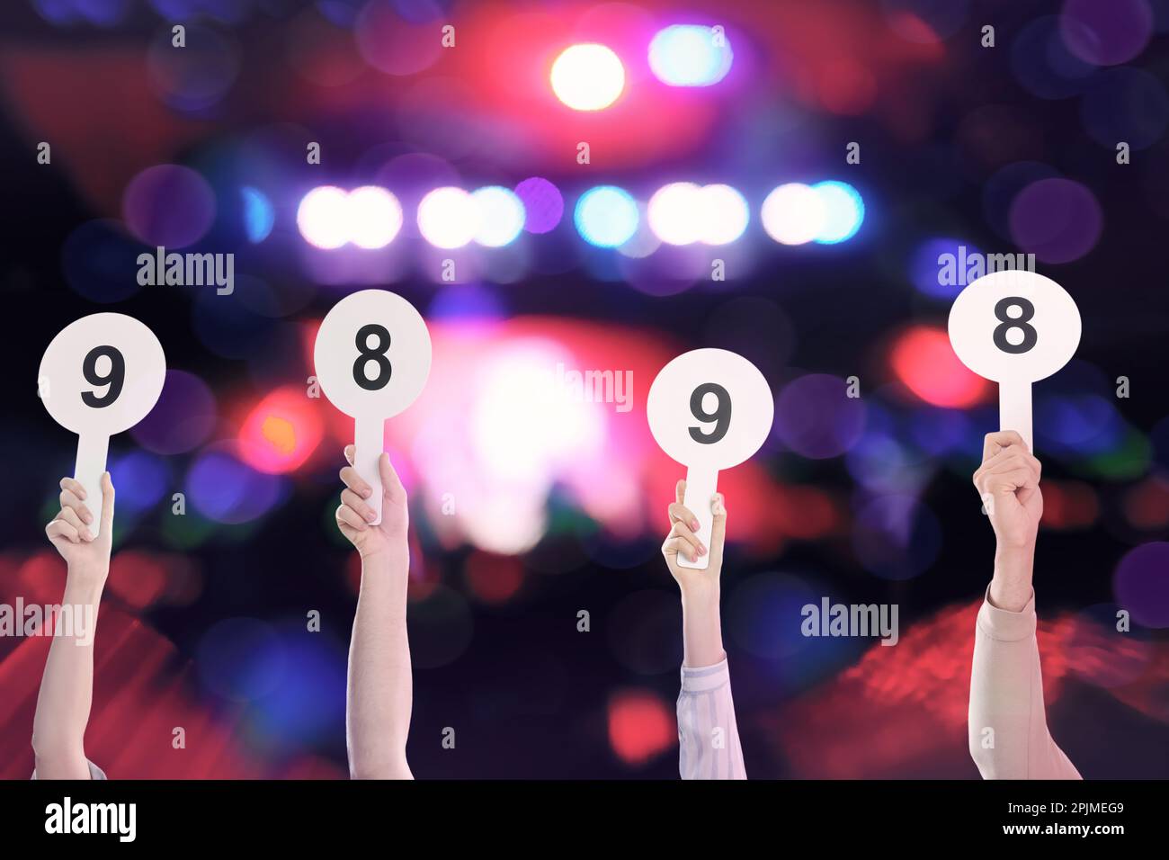 Panel of judges holding signs with different score against blurred ...