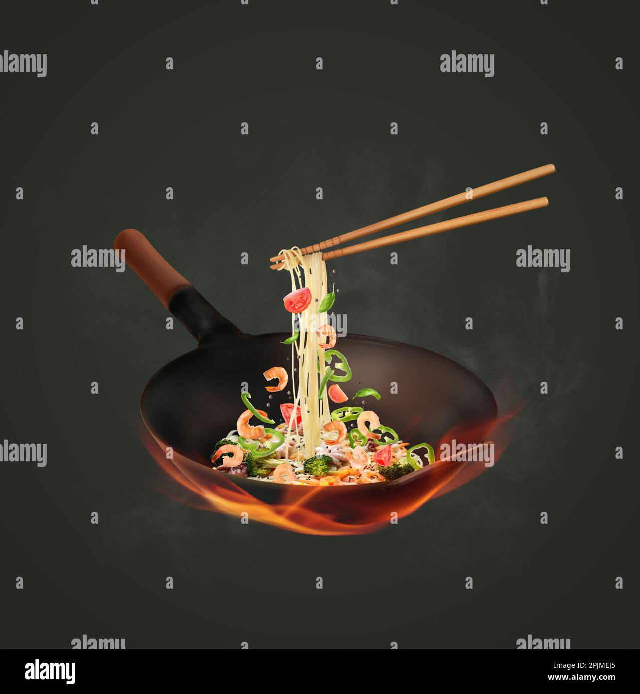 Wok with tasty ingredients and fire on dark background Stock Photo - Alamy