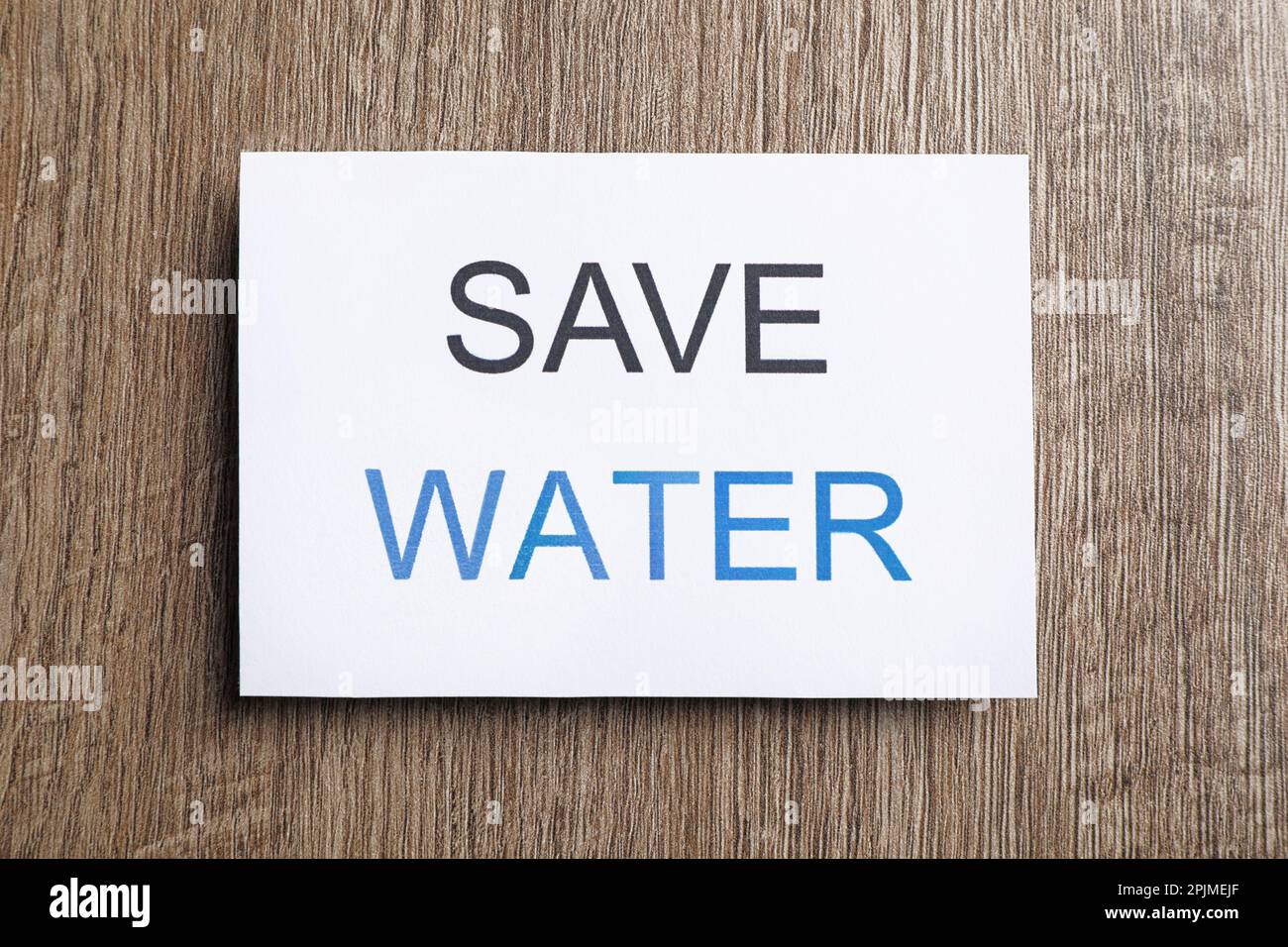 Card with words Save Water on wooden table, top view Stock Photo - Alamy