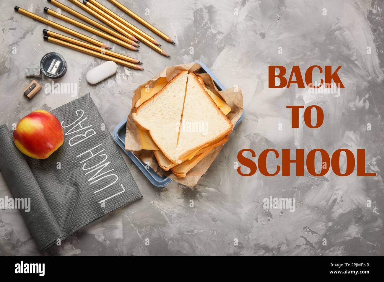 Flat lay composition with lunch box, tasty sandwich and stationery on ...